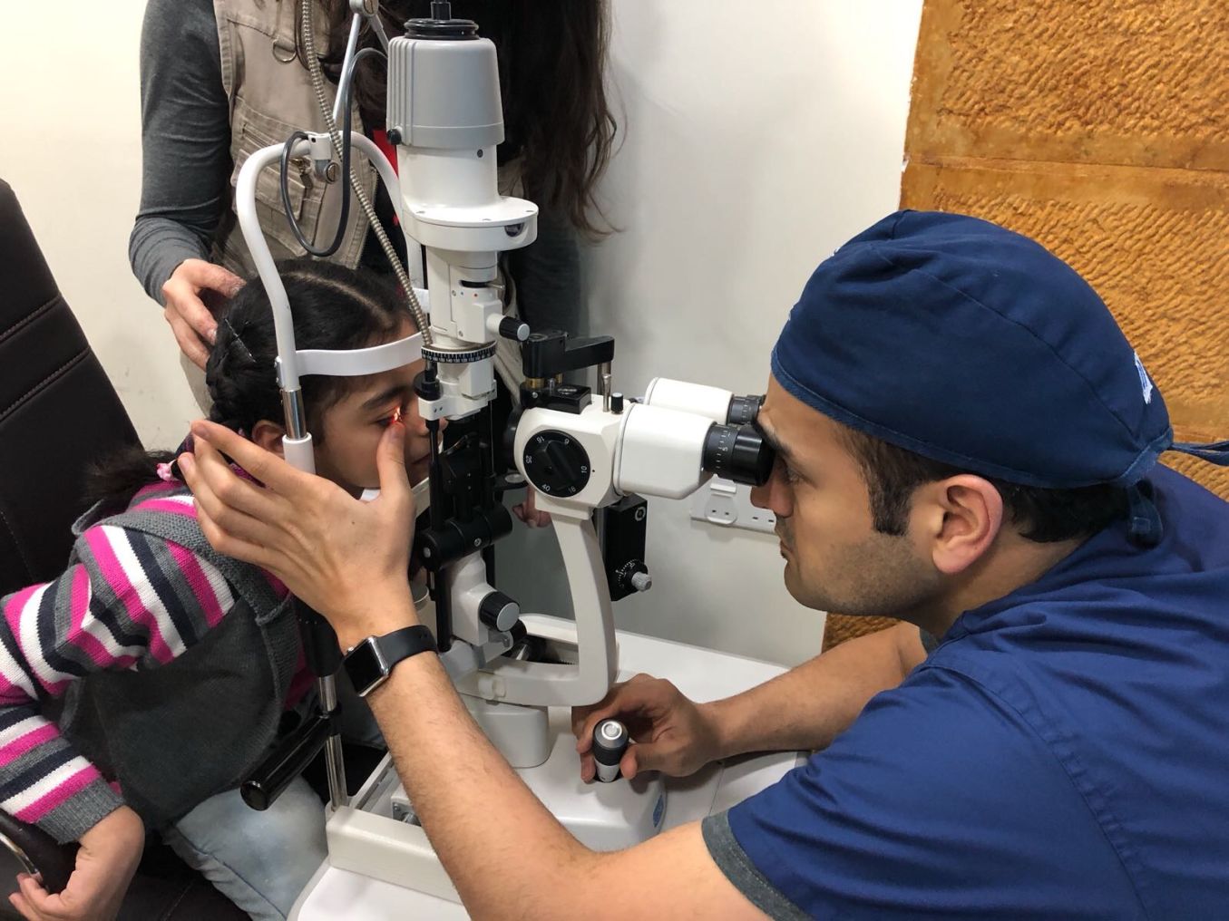 A Syrian girl has her vision checked by Dr. Behshad. Many of the ...