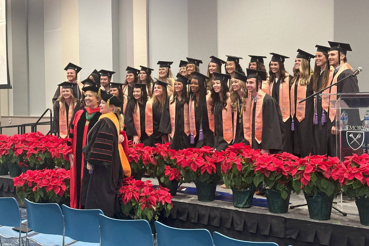Students tip their hat and celebrate December graduation