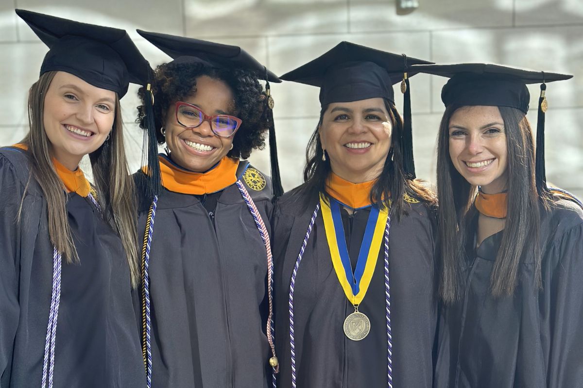 Students tip their hat and celebrate December graduation