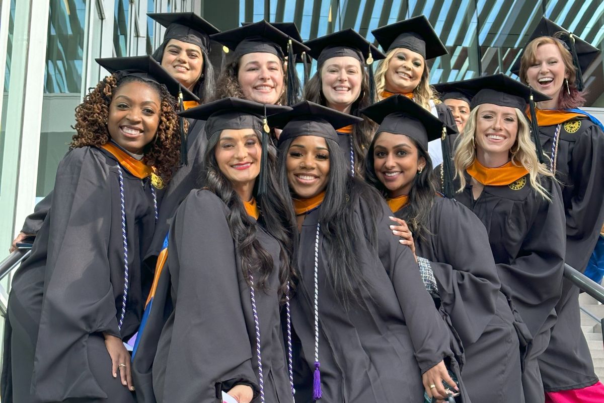 Students tip their hat and celebrate December graduation