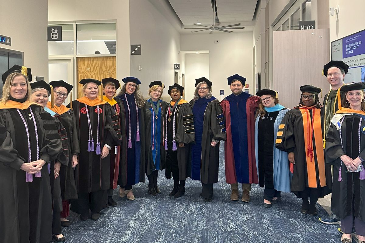 Students tip their hat and celebrate December graduation